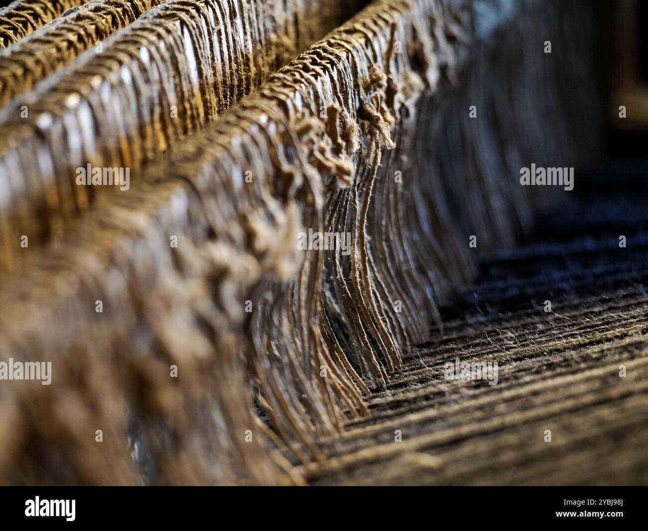 An Old wooden hand loom. Ancient weaving loom in interior of wooden log ...