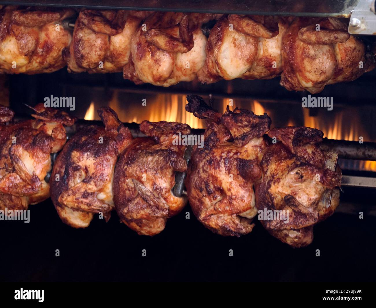 many chickens on the rotisserie Close-up shot of a steamy rotisserie ...
