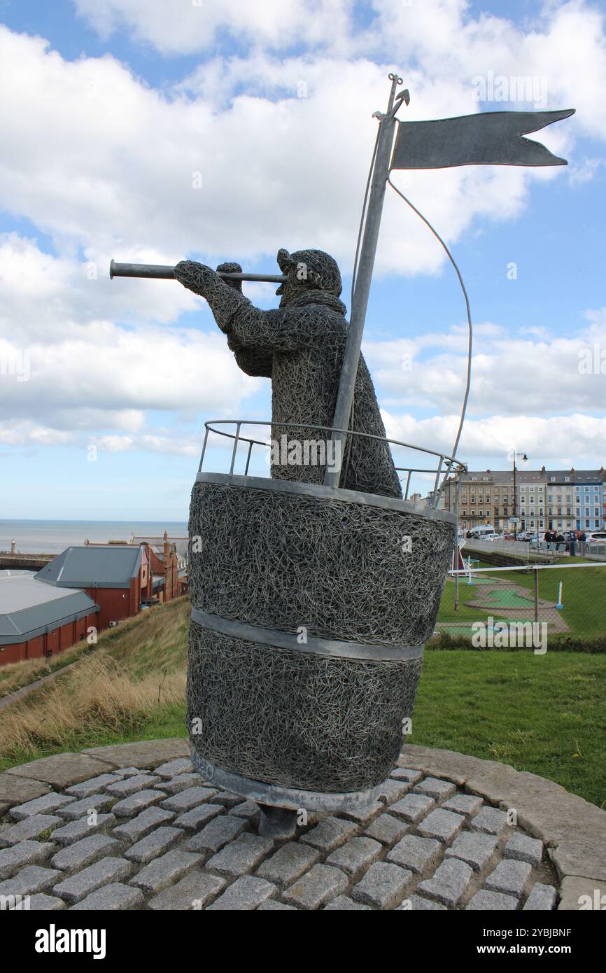 Wire Statue in Whitby, UK. Seaman looking out to sea through his ...