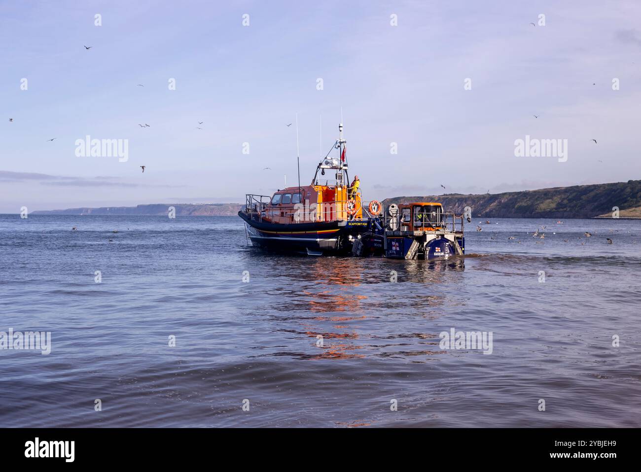 RNLI - Royal National Lifeboat Institution rescue workers landing ...