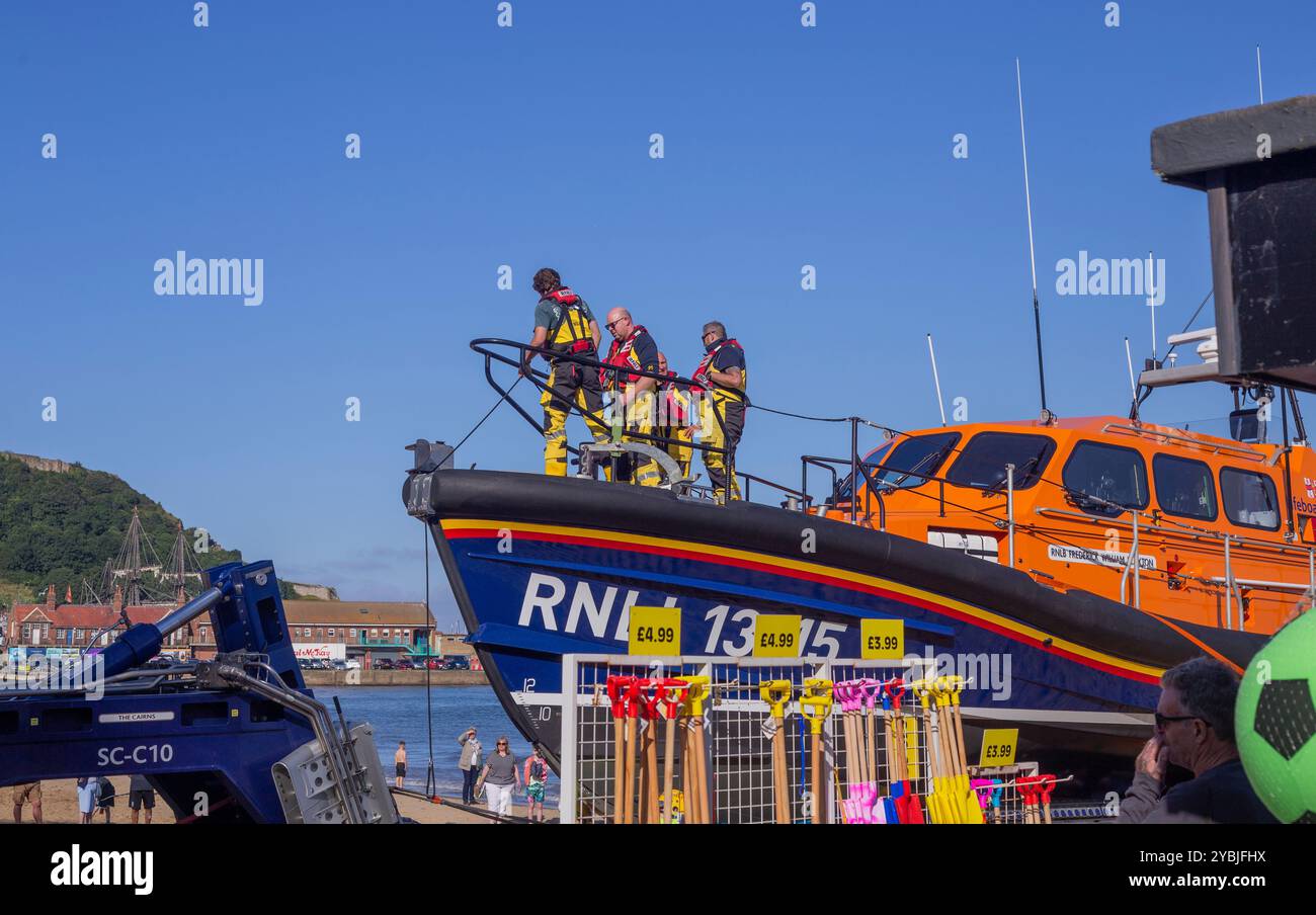 RNLI - Royal National Lifeboat Institution rescue workers landing ...