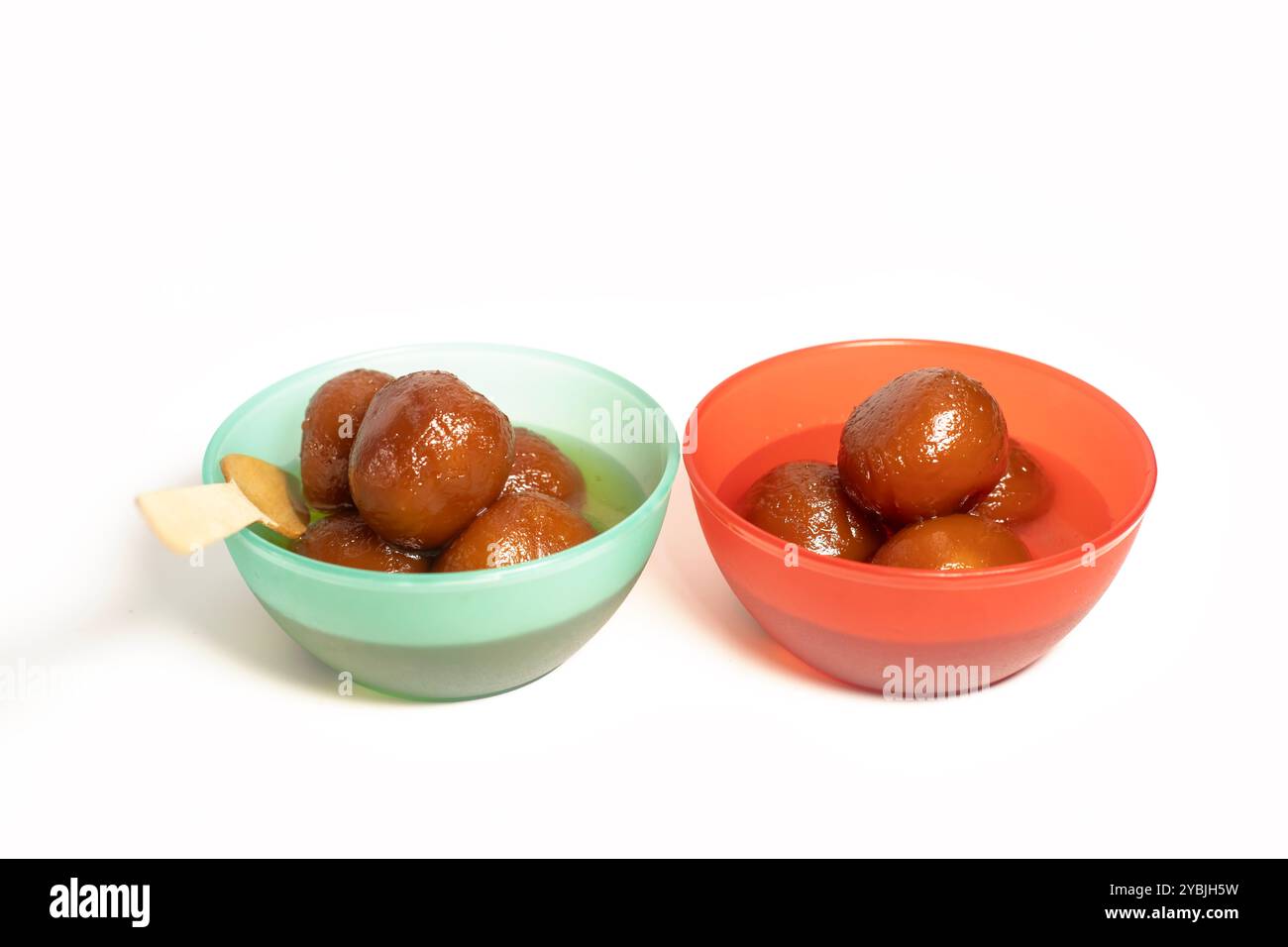 Two bowls filled with delicious Indian dessert Gulab Jamun in red and ...