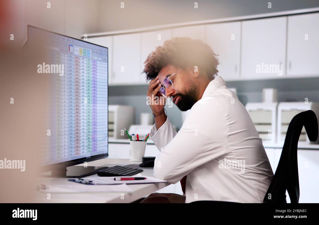 Data Analyst African Man Using Spreadsheet On Computer Stock Photo - Alamy