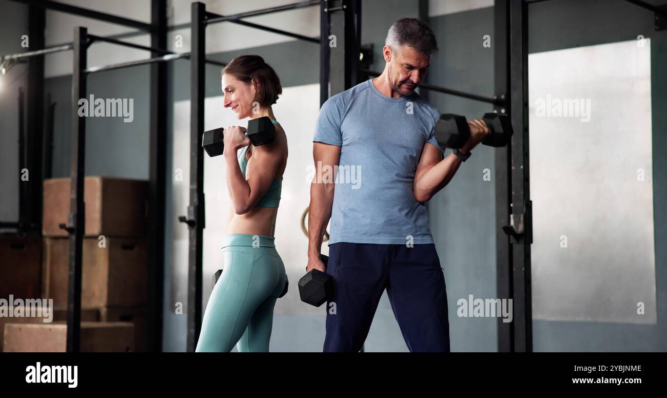 Fitness Couple Doing Weight Training Muscle Exercise In Gym Stock Photo ...