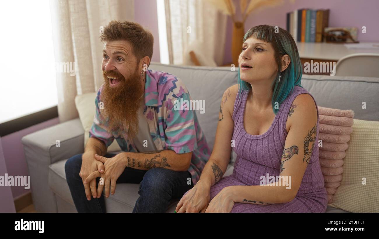 Man and woman sitting together in a cozy living room, both laughing and ...