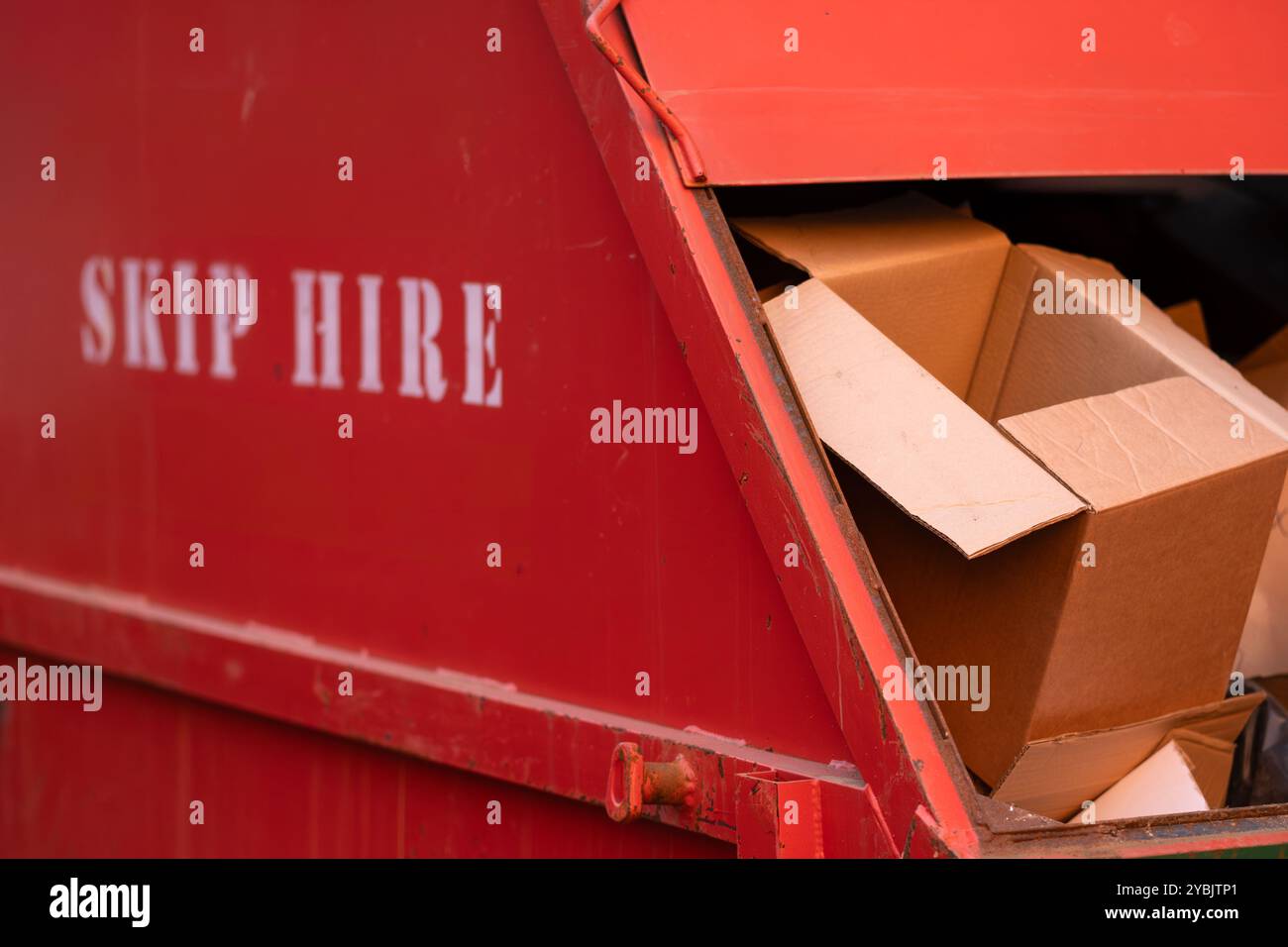 A Red Hired Skip Or Dumpster Filled With Cardboard Boxes Stock Photo ...