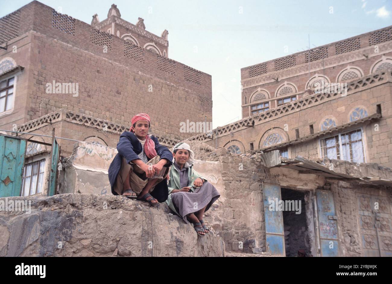SANAA, YEMEN-APRIL 25,2011: Two men sitting on a rock in front of ...