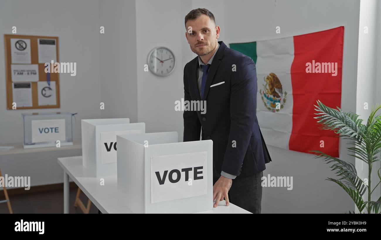 A man in a suit stands by voting booths with a mexico flag in the ...