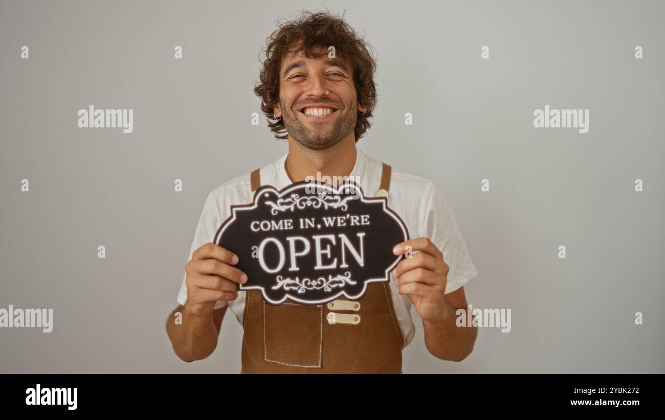 Smiling man holding an open sign isolated over a white background Stock ...