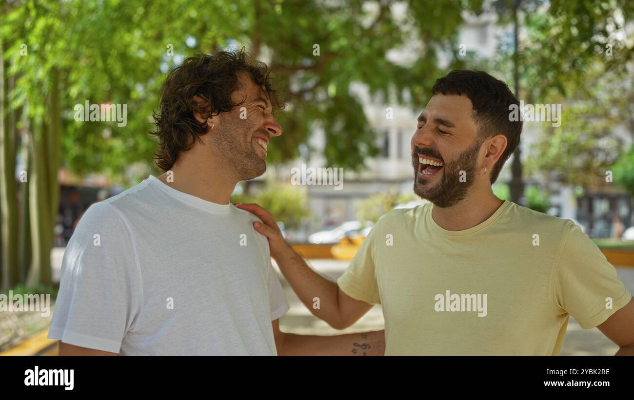 Men laughing together in an outdoor urban park, sharing a joyful and ...