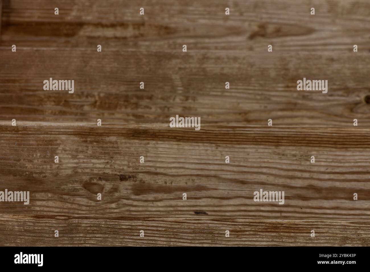 The warm, rustic wooden surface depicts rich grains and subtle ...