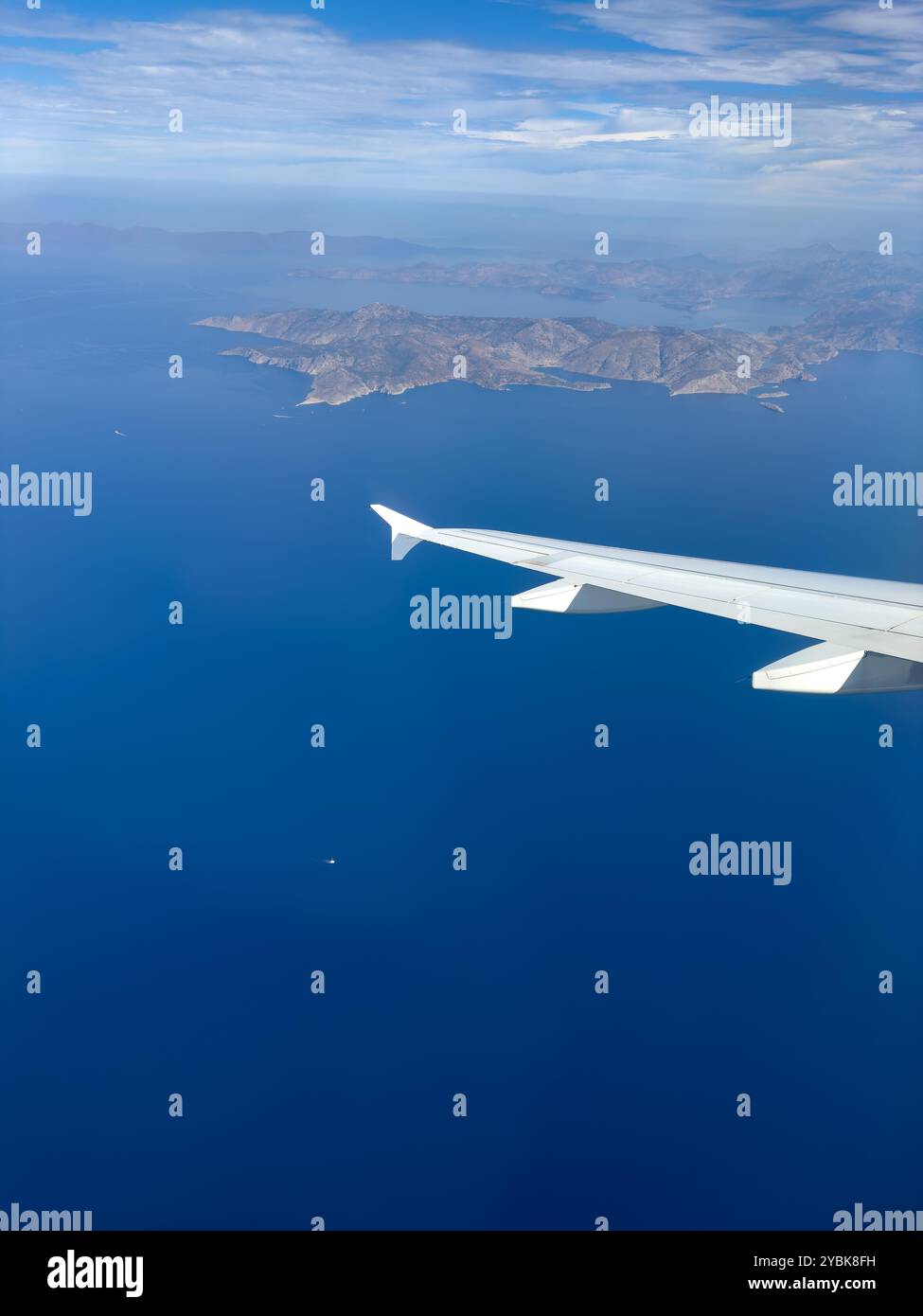 Aerial View of Rugged Island and Deep Blue Ocean Captured From a Plane ...