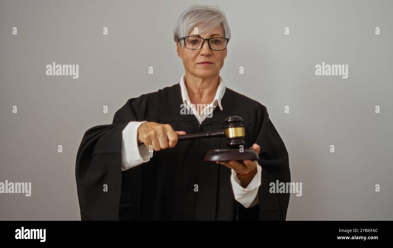 Woman judge holding gavel wearing glasses and judicial robe isolated on ...