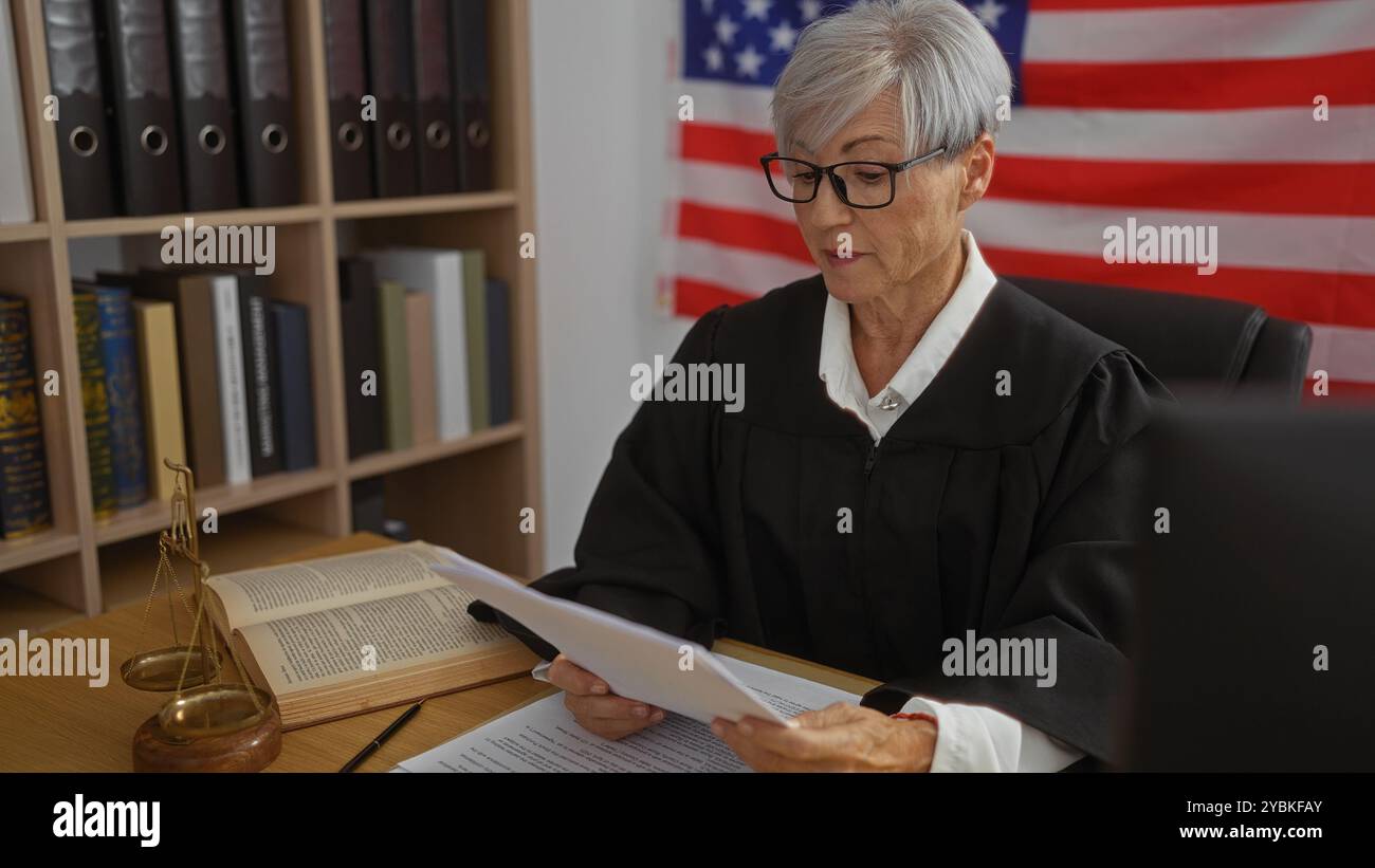 Elderly woman judge with short grey hair reading documents in a ...