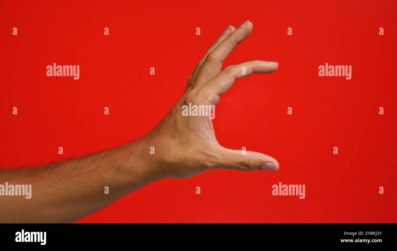 Man hand reaching out against vibrant red background, highlighting ...