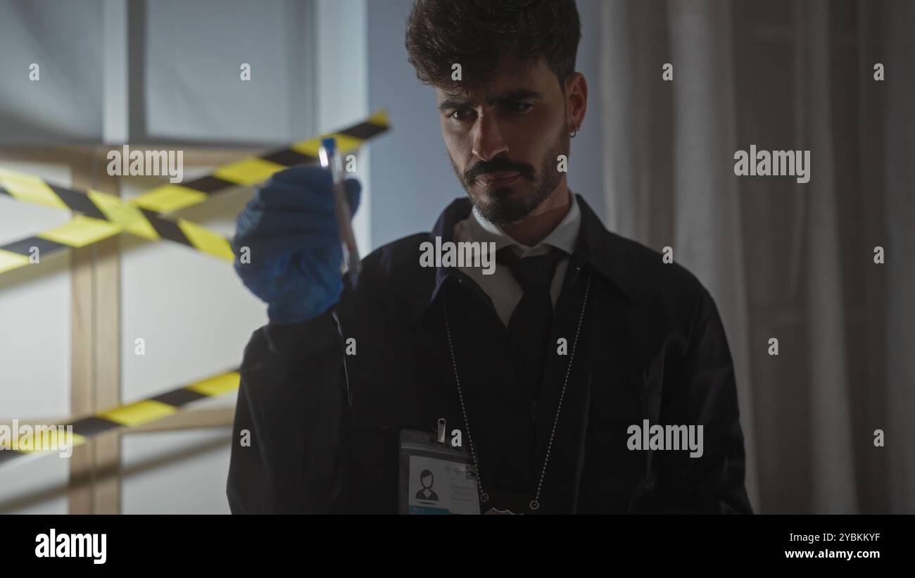 Handsome hispanic detective analyzing evidence at indoor crime scene ...