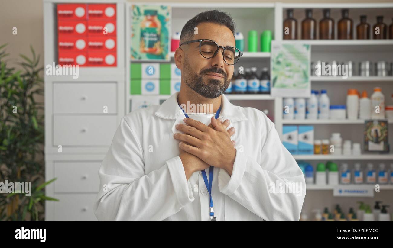 A handsome hispanic man pharmacist stands gratefully in an indoor ...