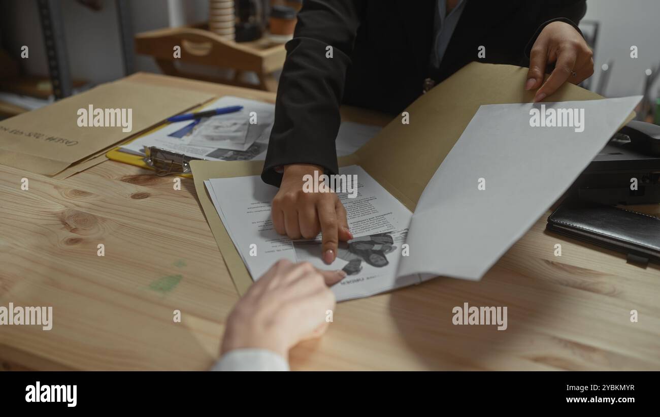 Two women in a police station inspect documents and evidence for an ...