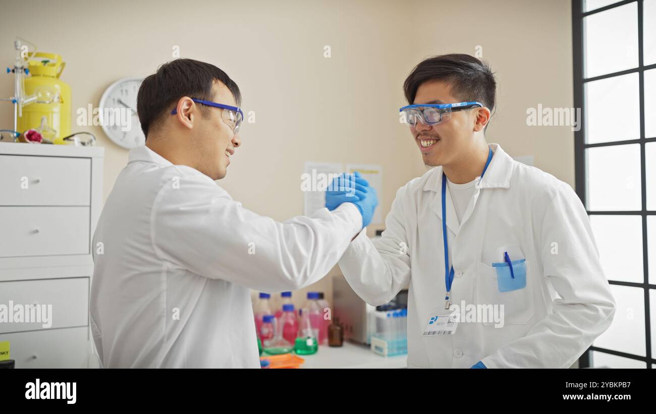 Two scientists shaking hands in hi-res stock photography and images - Alamy