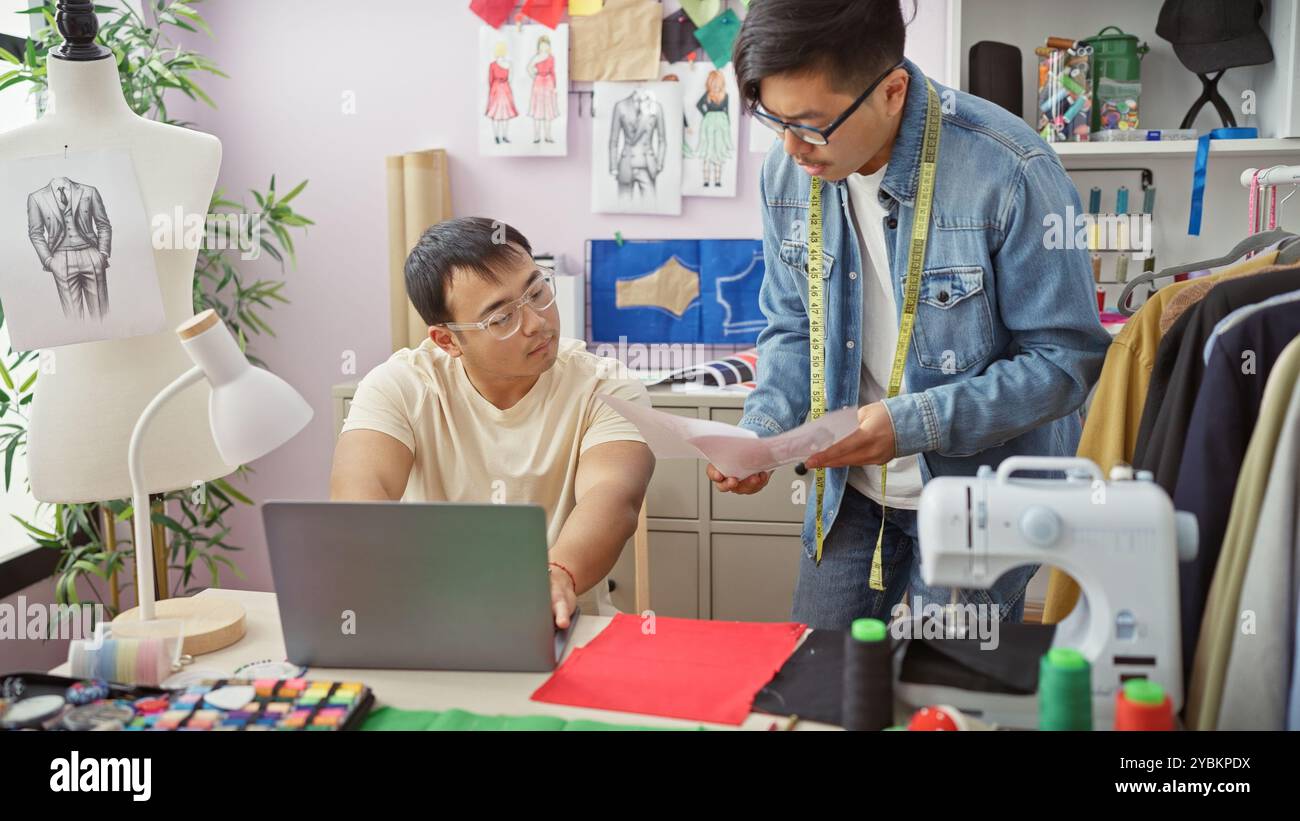 Two men collaborating in a tailoring shop with fabric, designs, sewing ...