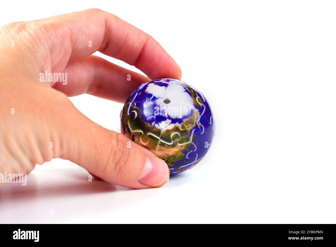 Creative representation of Earth through a globe puzzle being held in ...