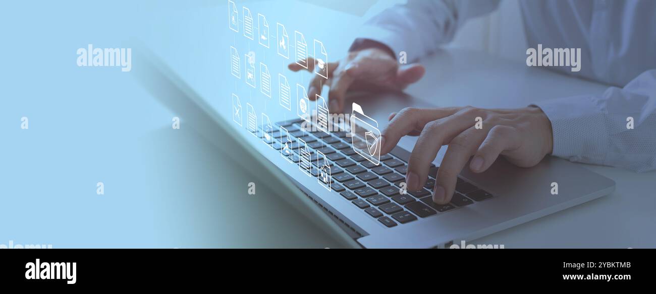 A person types on a laptop keyboard with digital icons of documents and ...