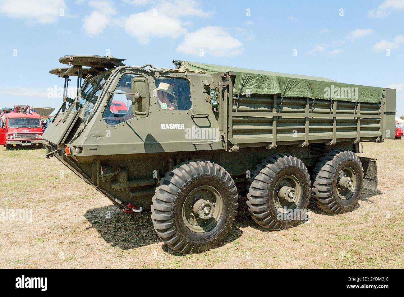 A 1967 Alvis Stalwart 6x6 Amphibious Truck driving around the ring at ...