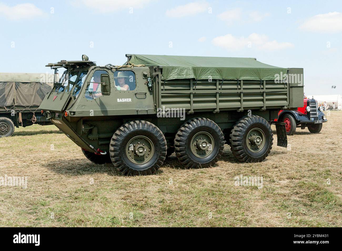 A 1967 Alvis Stalwart 6x6 Amphibious Truck driving around the ring at ...