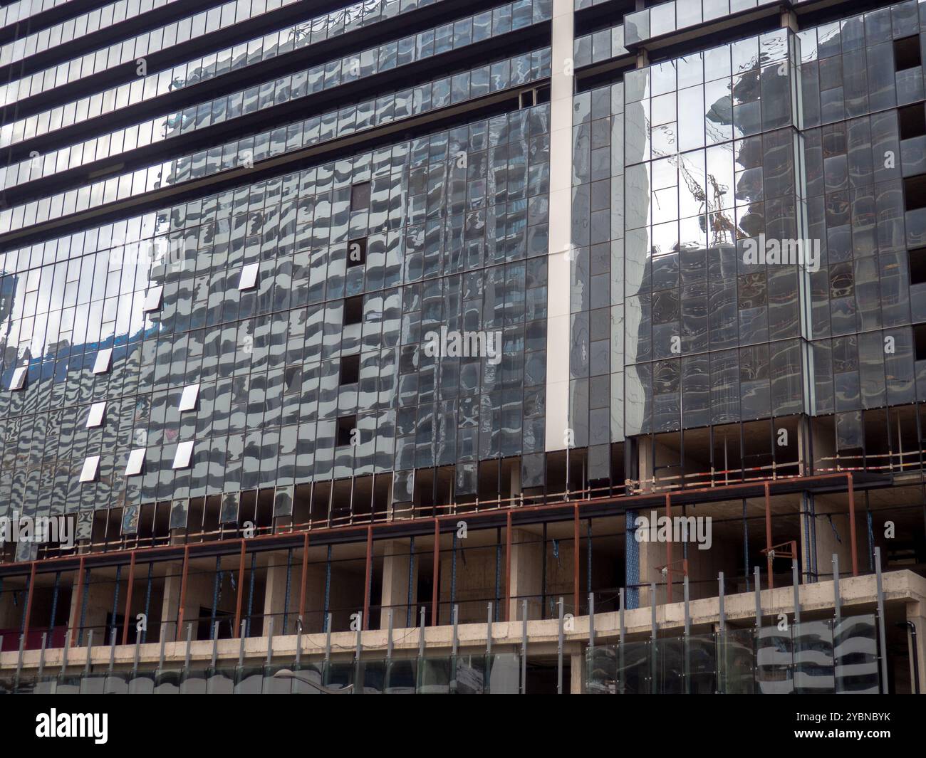Construction of a modern multi-storey building. Glazed facade ...