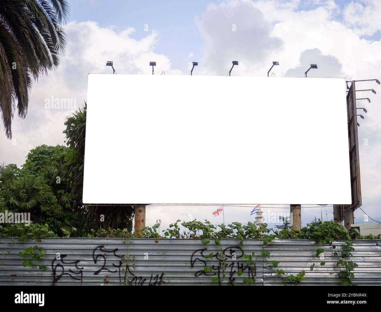 Large billboard mockup. Product promotion. Billboard near the palm ...