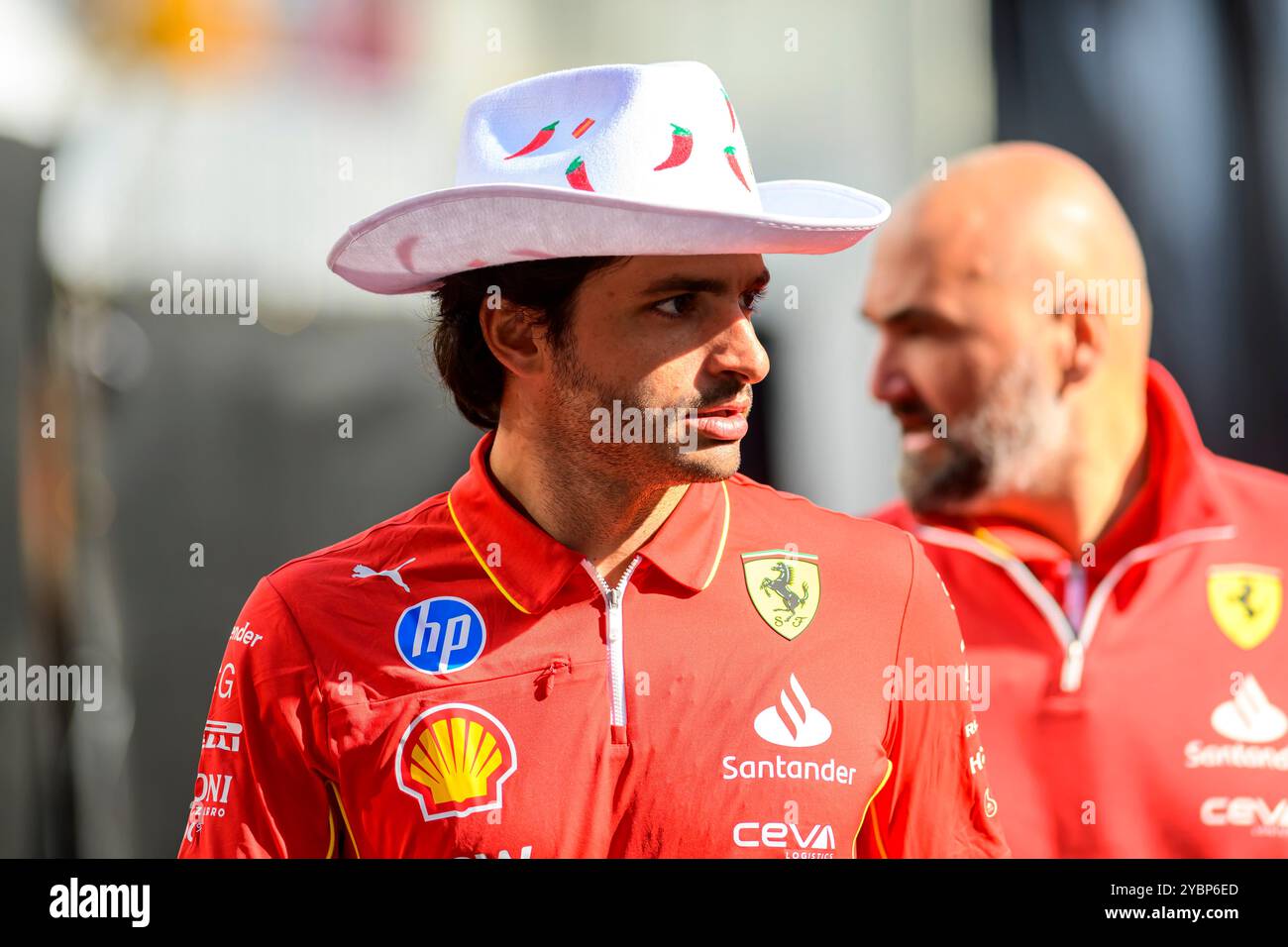 Scuderia Ferrari driver Carlos Sainz (center), of Spain, enters the ...