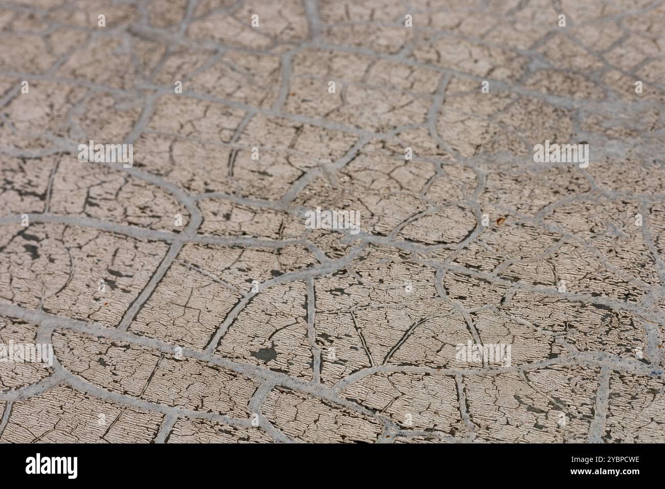 Intricate patterns on cracked ground showcasing drought conditions in a ...