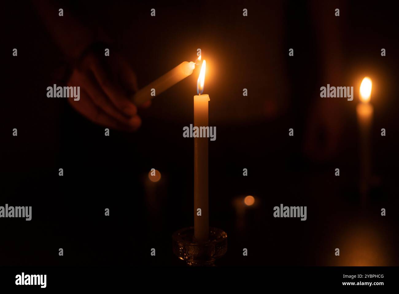 Human hand lighting candles hi-res stock photography and images - Alamy