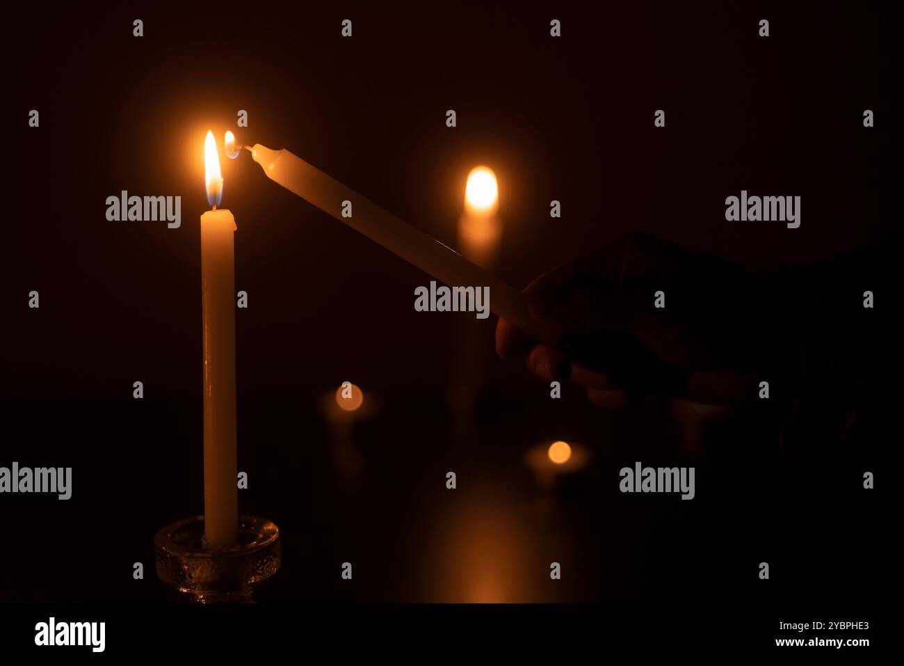 Human hand lighting candles hi-res stock photography and images - Alamy