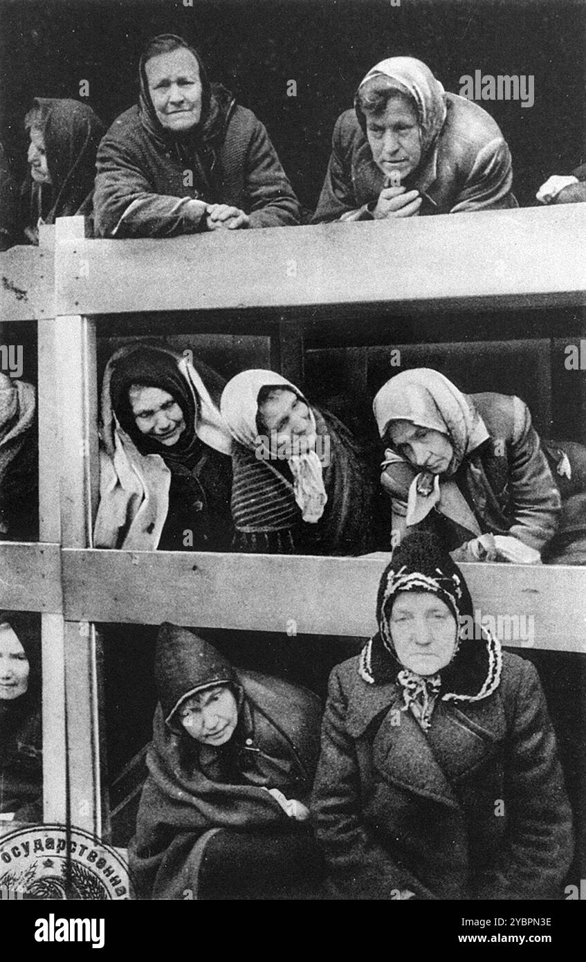 Former women prisoners on the wooden bunks that served as beds, in the ...