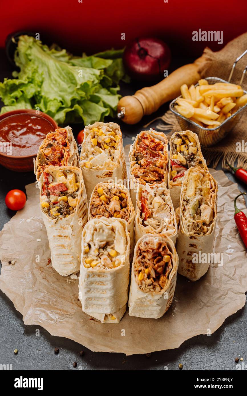 Assorted grilled wraps with diverse fillings, perfect for a party ...