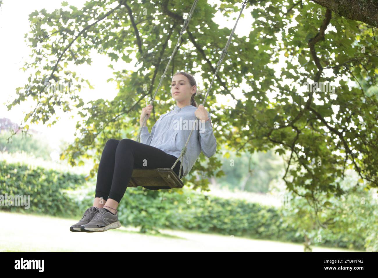 Girl swinging on tree hi-res stock photography and images - Alamy