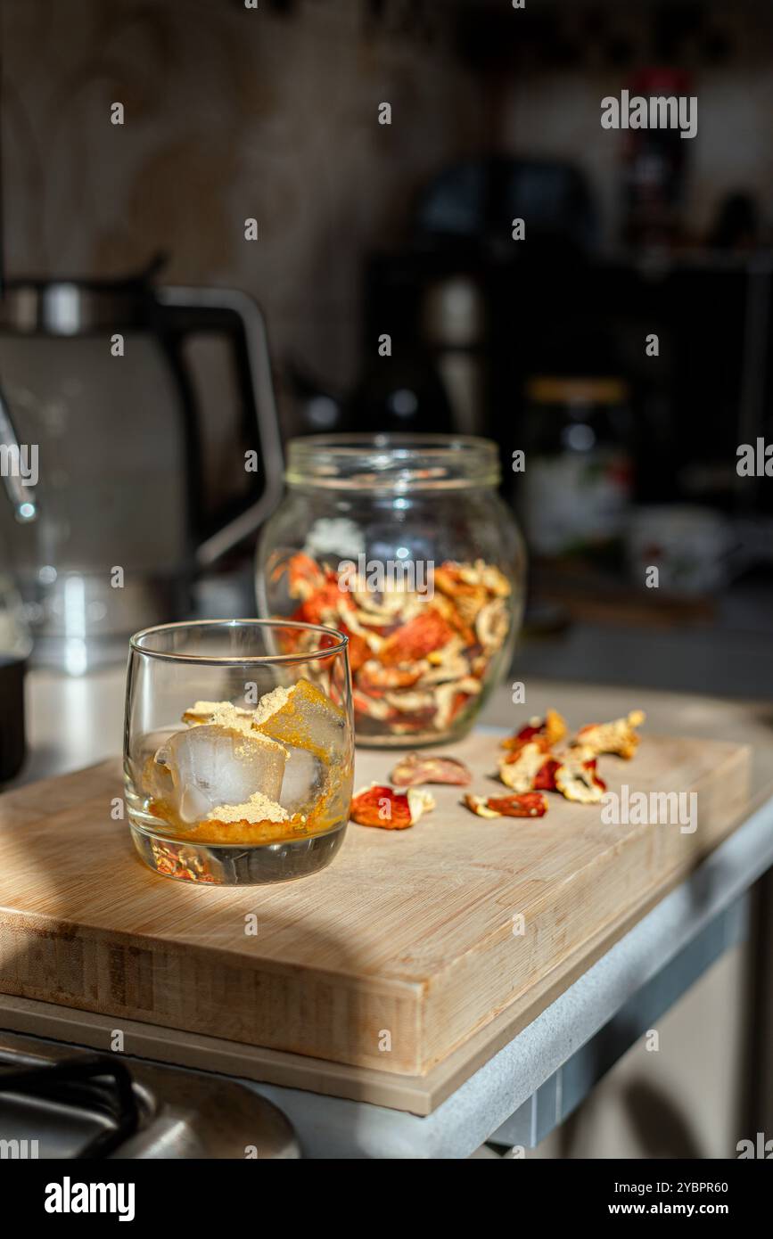 Preparation of fly agaric drink, ground powdered dry mushroom on ice ...
