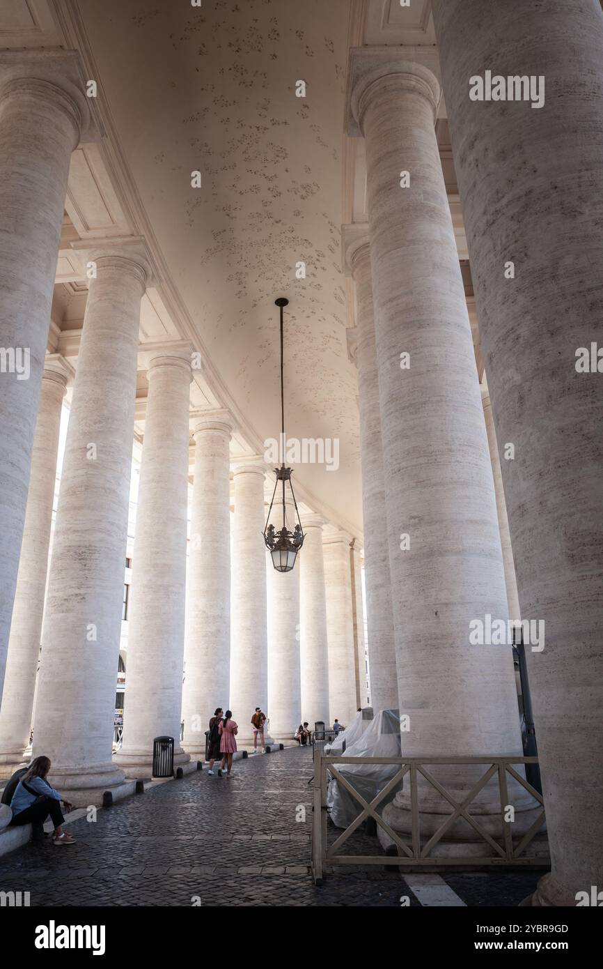 VATICAN - JUNE 15, 2024: Tourists passing by the st peter colonnades ...