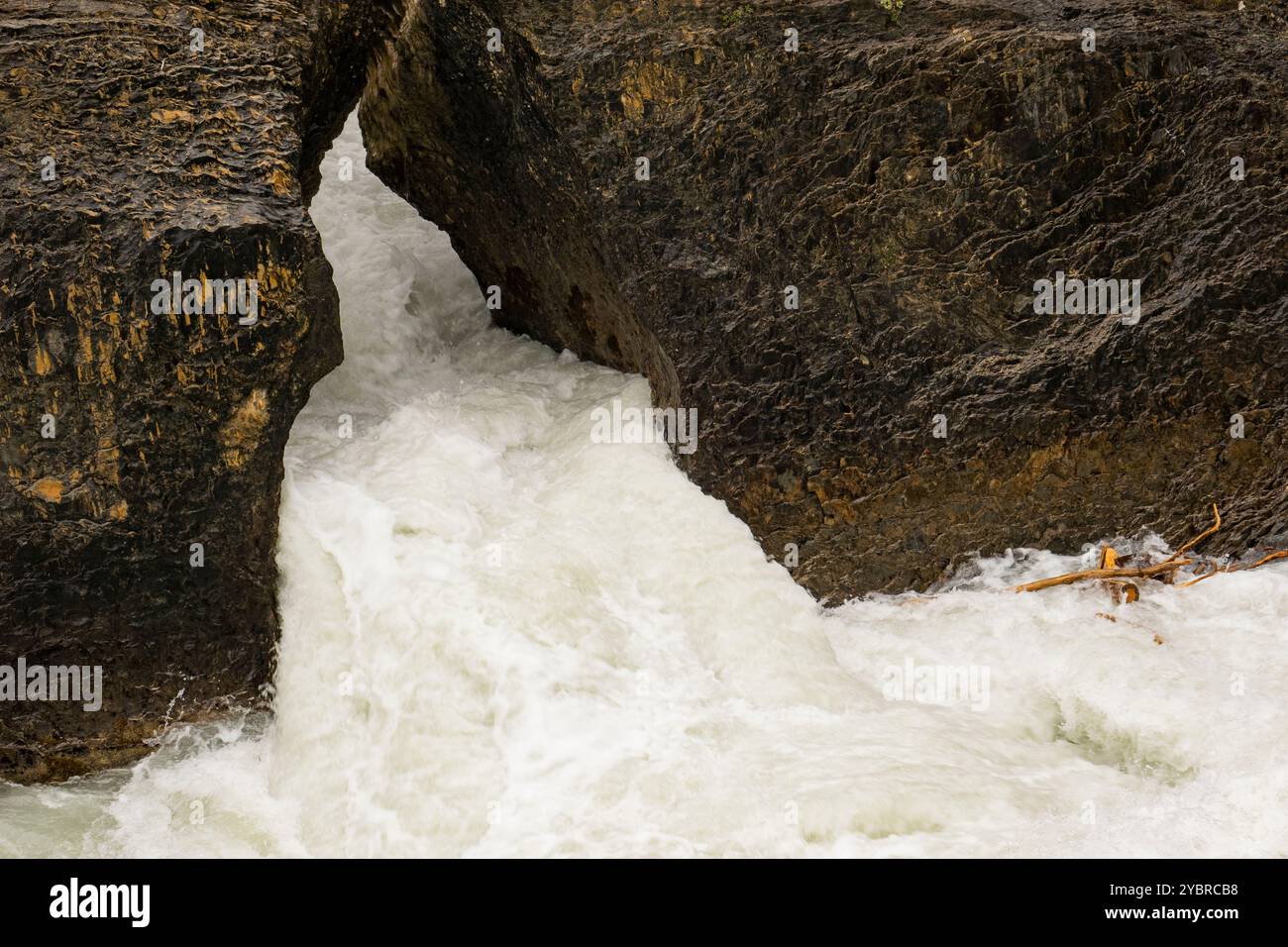 The Kicking Horse River flows under the Natural Bridge in Yoho National ...