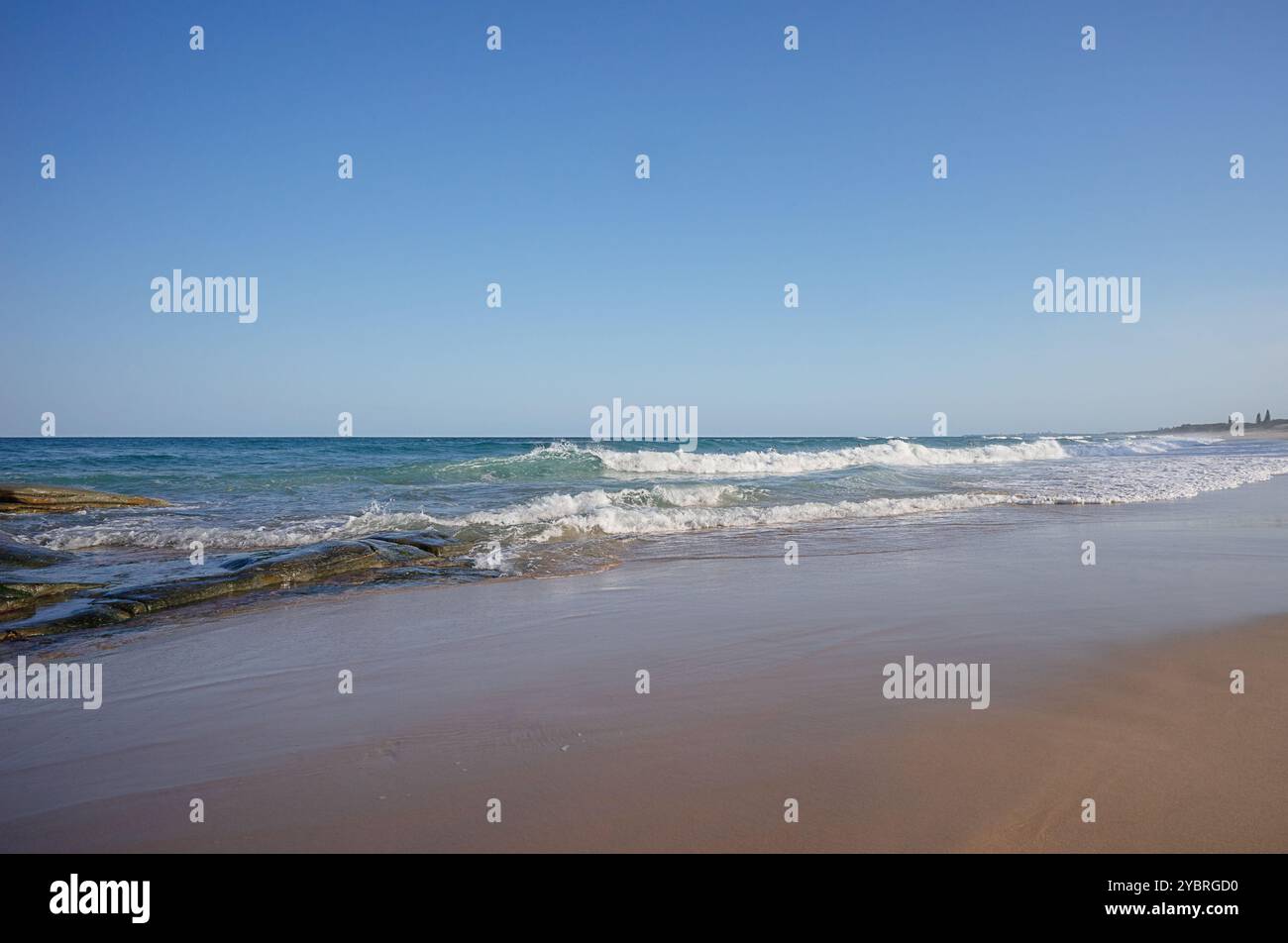 Surf waves breaking along the beach south from Point Cartwright ...