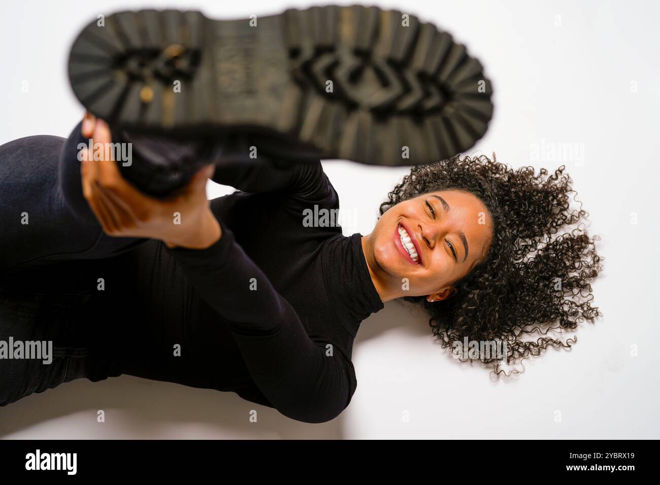 Young Black Woman Kicking Boot Upwards Studio Floor White Background ...