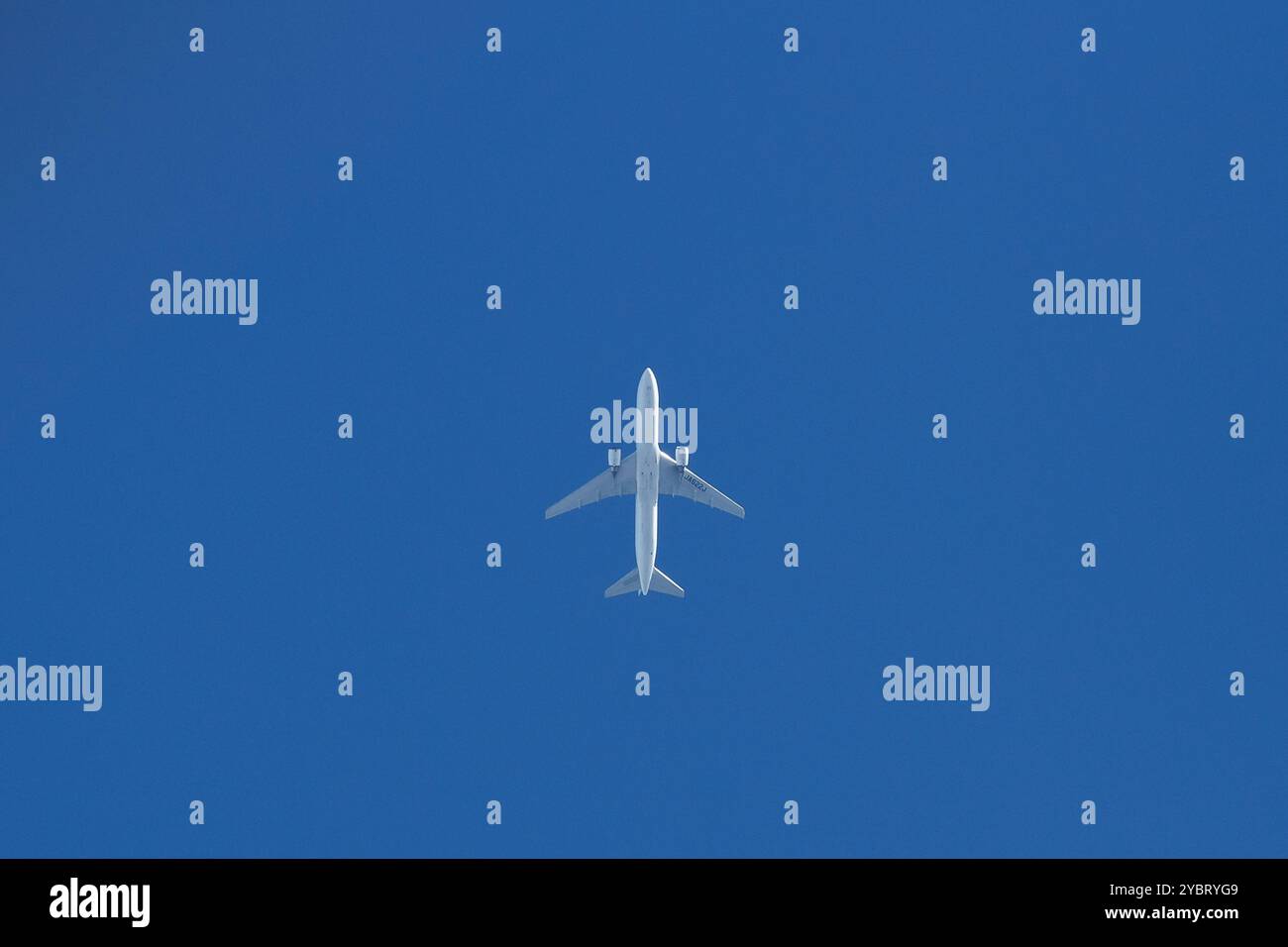 The underside of a Japan Airlines (JAL) Boeing 767-346(ER) flying in a ...
