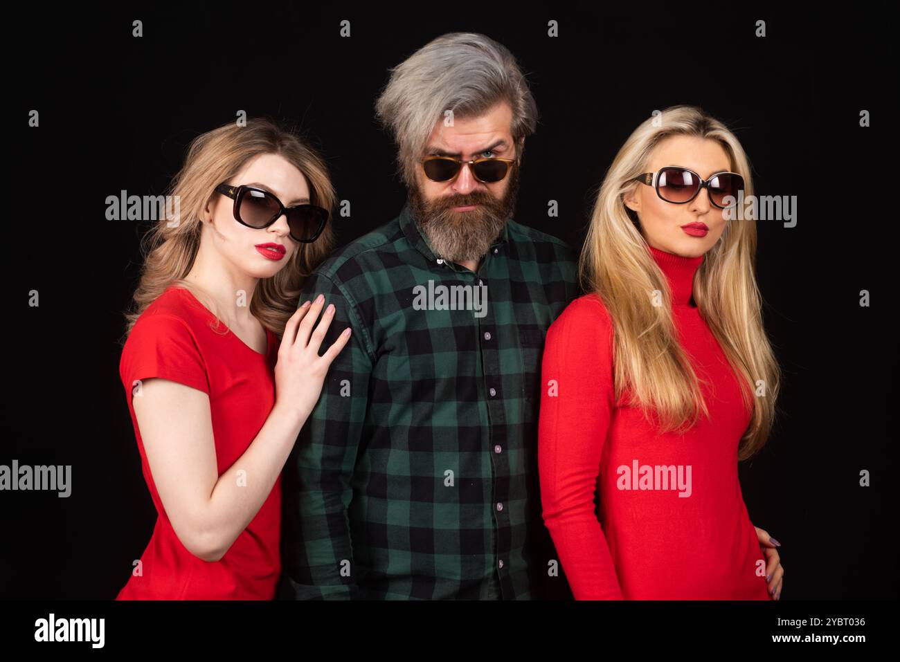 Group of fashion models posing in studio. Group of tree People. Friends ...