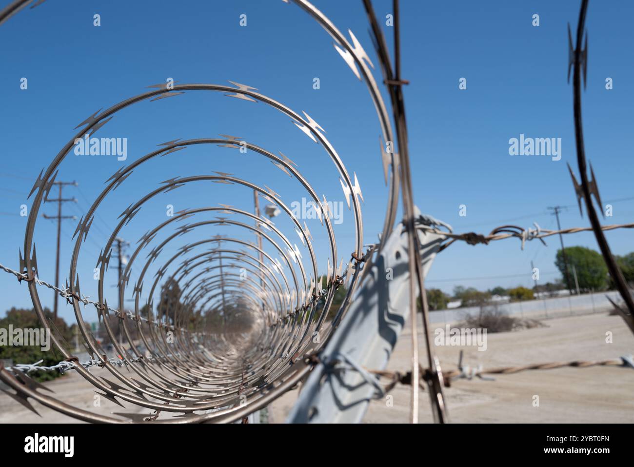 Barbed wire on the fence. Barbed wire fence delimiting the border of ...