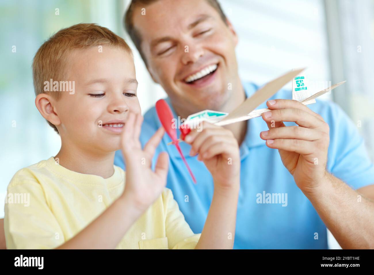 Toys, airplane and playful boy with dad, smile and fun on patio ...