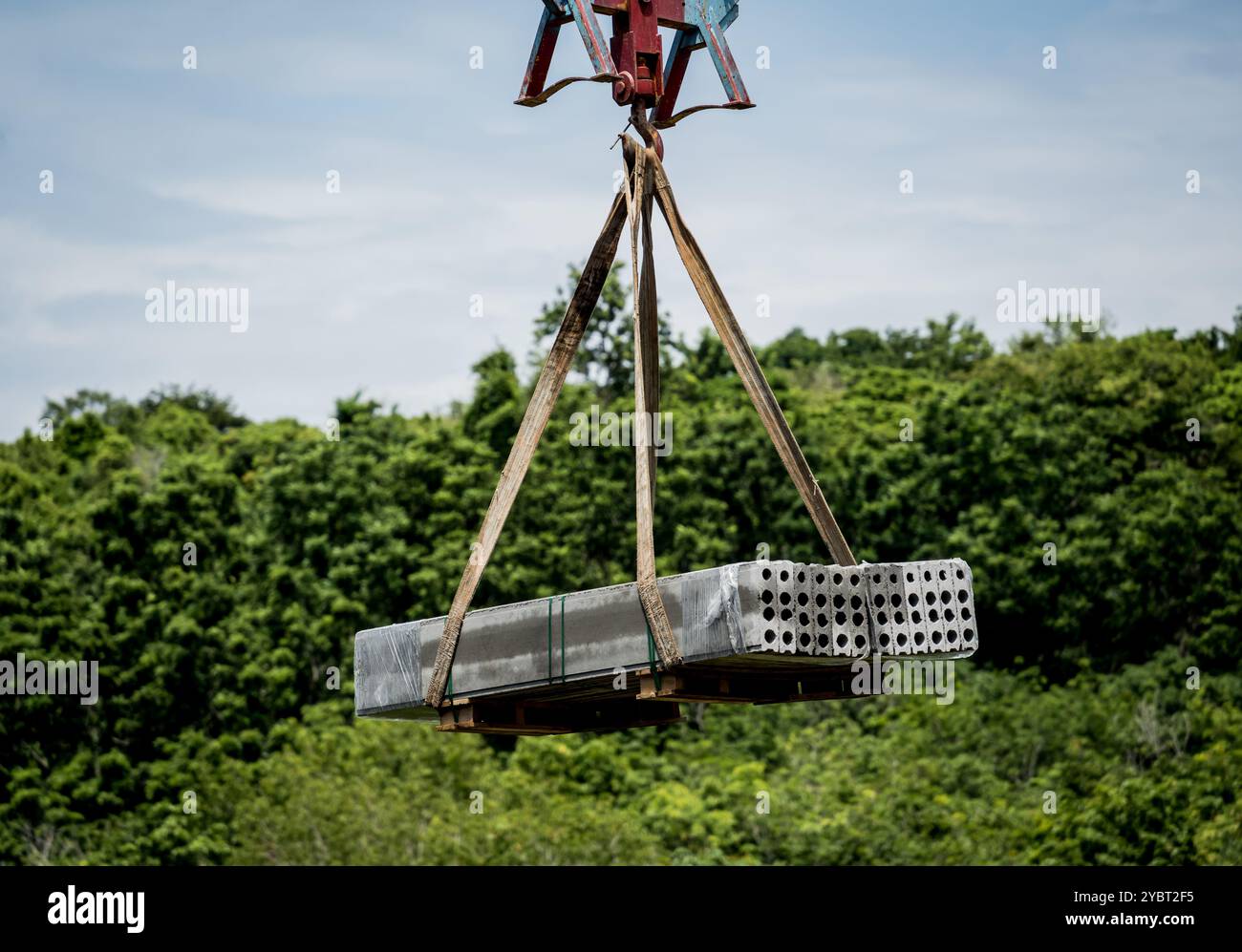 Heavy construction load being lifted by a tall crane Stock Photo - Alamy