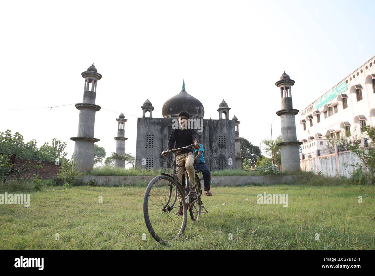Kids ride a cycle at the compound of Mini Taj Mahal, officially known ...