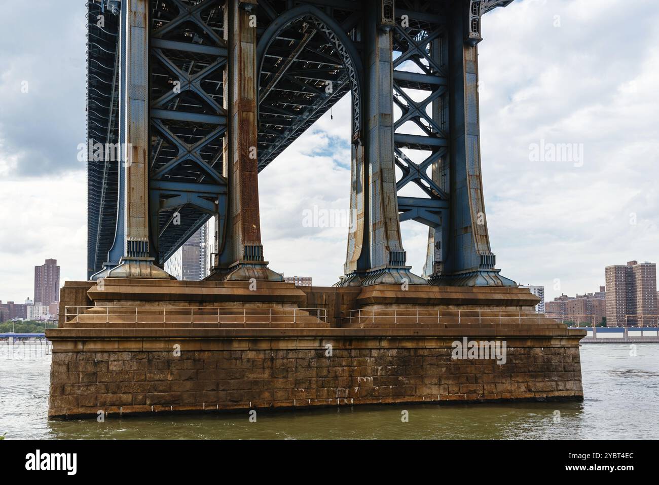 Detail of Pillar of Manhattan Bridge against cityscape of New York City ...