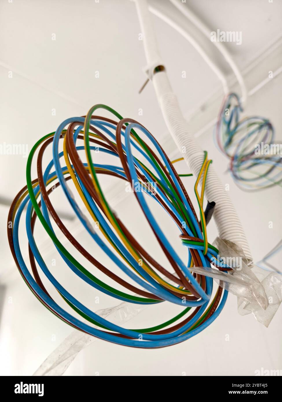 A collection of various wires is hanging down from the ceiling Stock ...